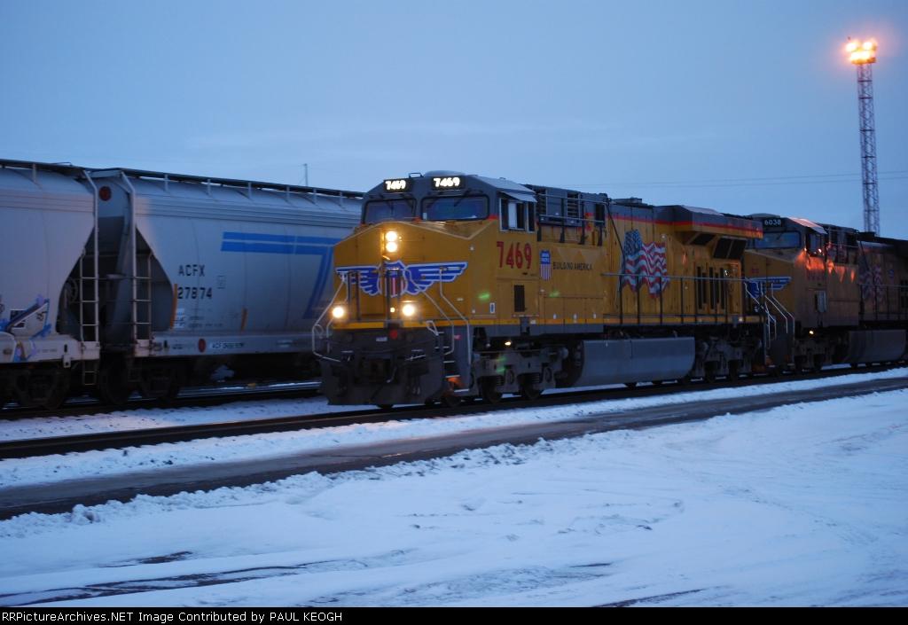 UP 7469 with UP 6038 2d unit pulls east towards the rising sun in this early am shot.